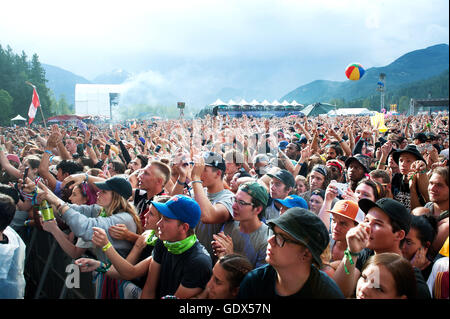 Huge crowds the outdoor rock concerts. Fans cheer in the rain at the ...