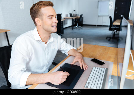Young handsome male designer working in the office Stock Photo - Alamy