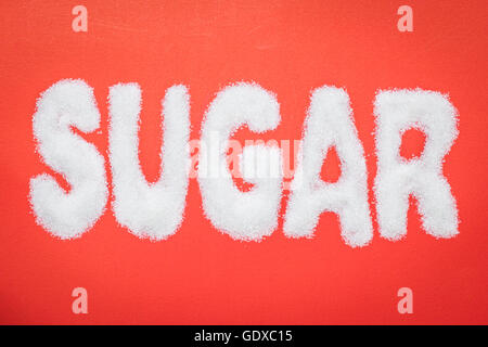 sugar text made from granulated sugar crystals with bowl and spoon on ...