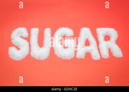 sugar text made from granulated sugar crystals with bowl and spoon on ...
