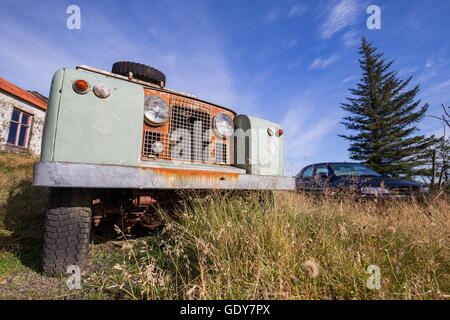 Car junkyard at a farm in Iceland, run down cars and run down buildings ...