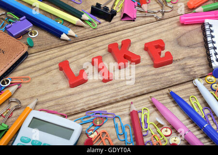 Like word and office tools on wooden table Stock Photo - Alamy