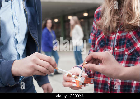 Female high school students smoking a cigarette Stock Photo - Alamy