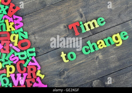 Tine to change word on wooden table Stock Photo - Alamy