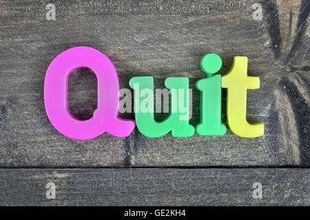 Quit word on wooden table Stock Photo - Alamy