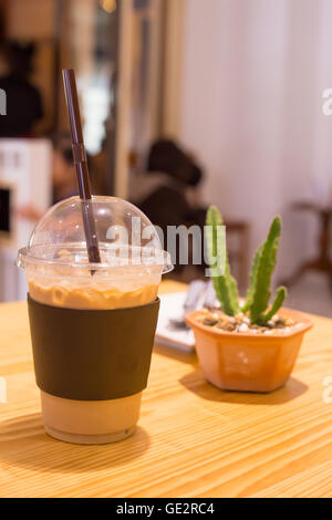 Ice cold coffee on a wooden table Stock Photo - Alamy