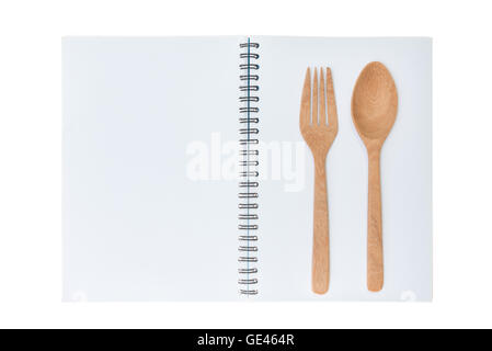 Wooden spoon and book on a wooden board with a checkered tablecloth ...