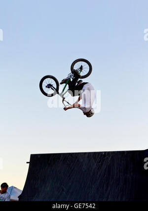 A person doing a back flip over a jump on a BMX bicycle Stock Photo - Alamy