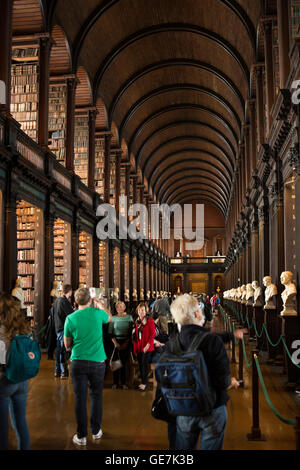 Dublin, Ireland: people visiting the Long Room of the Old Library at ...