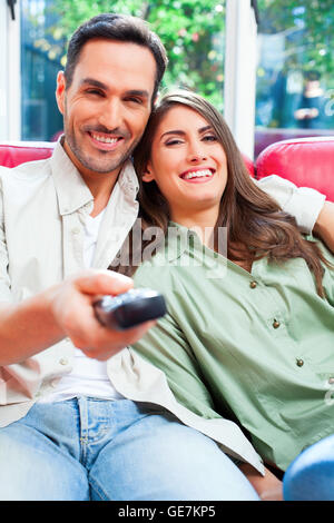 Young female is watching TV and sitting with white wine at home Stock ...