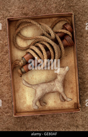 Cardboard box containing Victorian skipping rope and stained papier ...