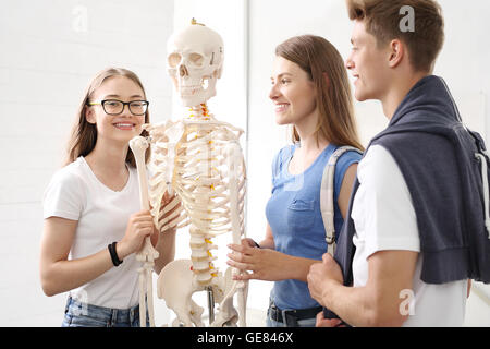 School, anatomy lesson, students watch a model skeleton Stock Photo - Alamy