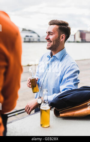 Two colleagues having a beer after work Stock Photo - Alamy