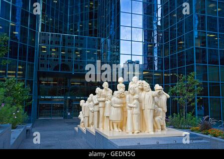 Illuminated Crowd Sculpture by Raymond Masson in front of a Stock Photo ...