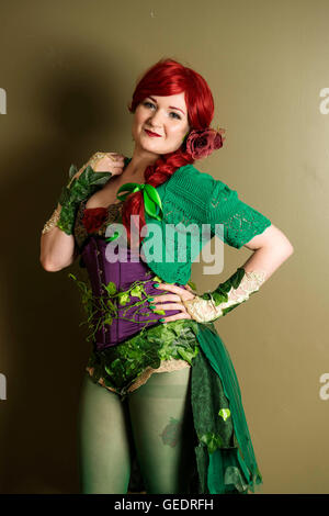 Cosplayer dressed as Poison Ivy poses for photographs at a Comic Con ...