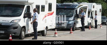 Neuenburg, Germany. 22nd July, 2016. Police officers inspect camper ...