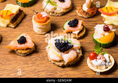 Exquisite selection of luxury canapes, appetizer ready to be served for ...