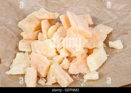 Cutting parmesan cheese crunches on the wood background Stock Photo - Alamy