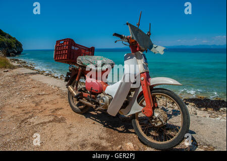 A lone, old moped on a deserted beach in Greece Stock Photo - Alamy