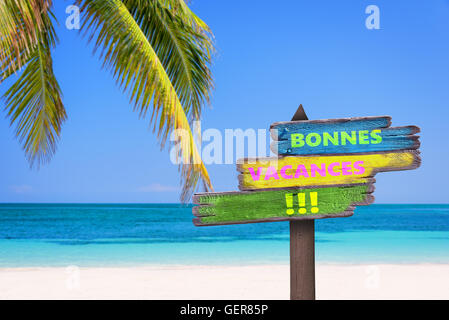 Bonnes vacances (meaning happy summer) written on a paper on colorful ...