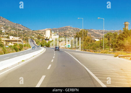 Mountain roads and serpentines of Crete, cars move along the winding ...