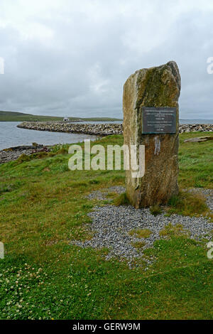 Causeway memorial stone and CalMac ferry by pier on Berneray Island ...