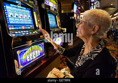 Senior woman playing slot machines in casino on cruise ship-Pacific ...