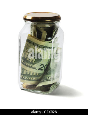 Dollars in a glass jar with coins on a dark blue background. Money ...