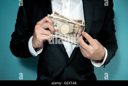 Businessman holding a lot of ten thousands yen Stock Photo - Alamy