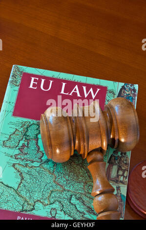 EU Law book with map of Europe front cover, on desk with judges gavel ...