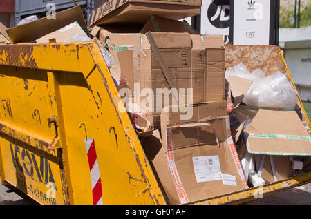 Cardboard boxes in skip Stock Photo - Alamy