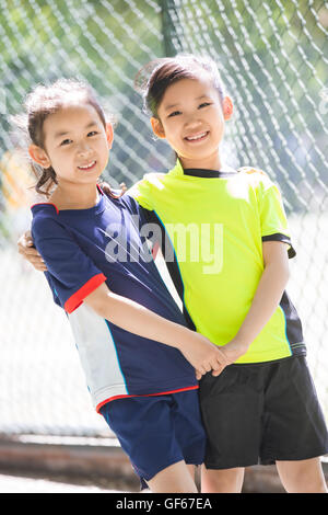 Selective focus on girls' soccer ball with a player on the grass field ...