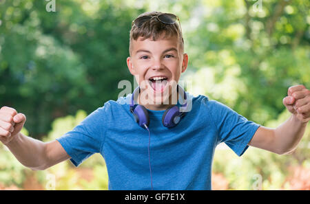 Teenage boy showing victory gesture on white background. Hello concept ...