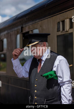 Volunteer train guard dressed in authentic uniform of the day at the ...