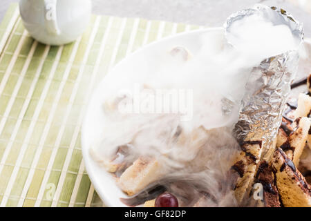 Honey toast and banana wtih dry ice on table background Stock Photo - Alamy