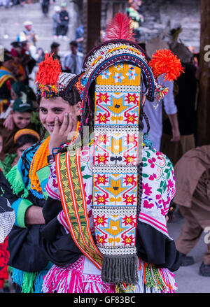 Kalash woman wearing a cowrie shell headdress (shushut) and coloured ...