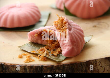 Tutu kueh with grated coconut filling; arranged on wooden block Stock ...