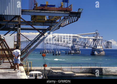 Massive cantilever gantries swing out over the reef at Aiwo, ready to ...