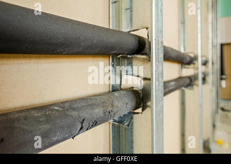 Water pipe going through partition wall Stock Photo - Alamy