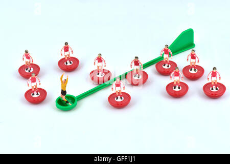 Subbuteo table football team players goalkeeper on a stick against a ...