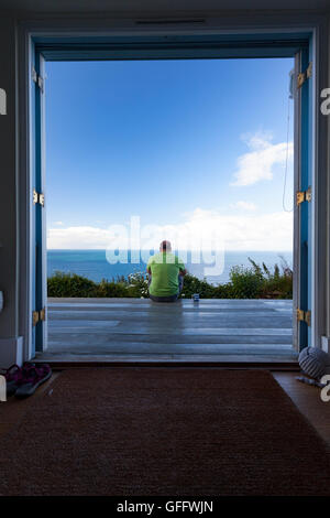 People sitting on the outdoor decking area of the Fistral Boardmasters ...