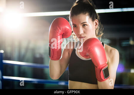 Female Chinese boxer practicing in boxing ring Stock Photo - Alamy