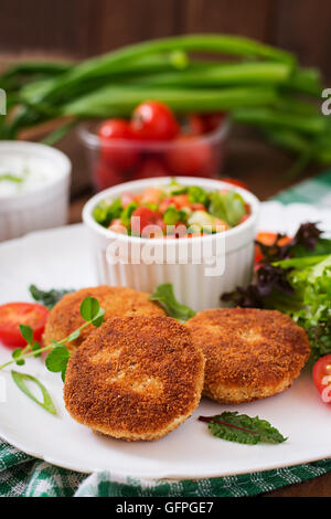 Small chicken cutlet with vegetables on a plate. Top view Stock Photo ...