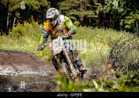 Enduro motorcycle rides through the mud with a big splash Stock Photo ...