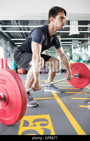 Athlete standing with wide legs apart at sports field Stock Photo - Alamy