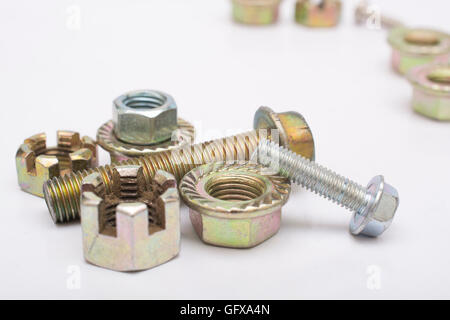 Different metal bolts and nuts on white background Stock Photo - Alamy