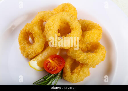 Fried Calamari rings with rosemary and lemon Stock Photo - Alamy