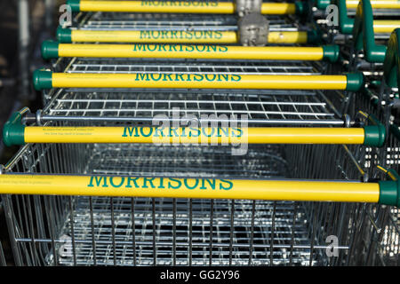 Row of Morrisons supermarket trollies lined up in the trolley bay ...