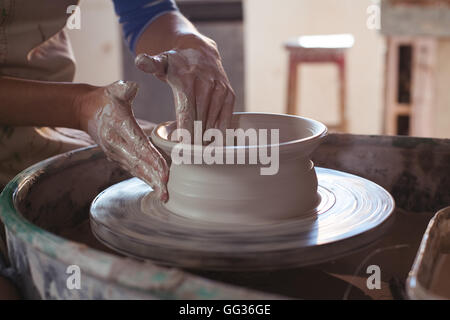 Mid section of female potter making pot Stock Photo - Alamy