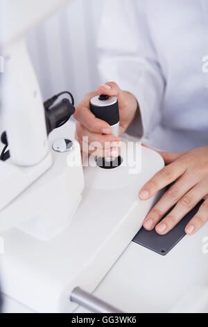 pretty young optometrist at work, examinating your eyes Stock Photo - Alamy